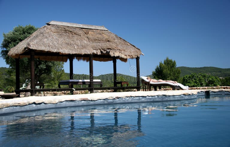 Swimming pool and tiki hut stock photo. Image of natural - 954806