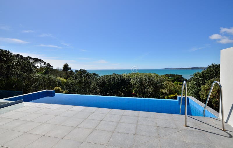 Infinity Swimming Pool with an Ocean View Stock Image - Image of steps ...