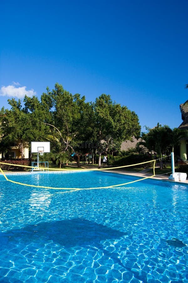 Swimming Pool with a Volleyball Net at a Resort in Stock Photo - Image ...