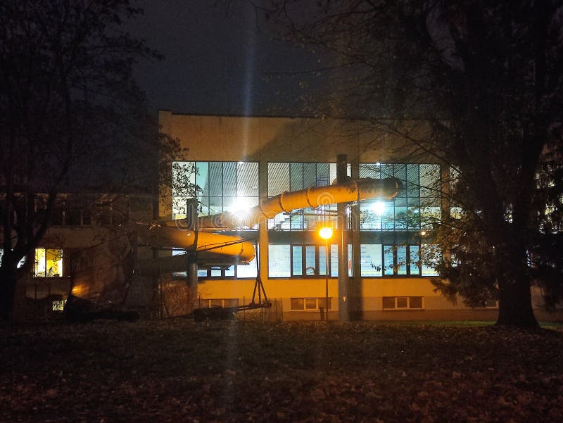 Swimming Pool with Water Slide Facing the Street at Night. Stock Photo ...