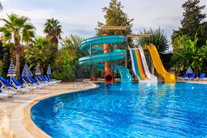 Swimming Pool with Water Slide at Tropic Summer Resort Stock Photo ...