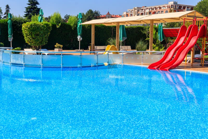 Swimming Pool with Water Slide at Tropic Summer Resort Stock Photo ...