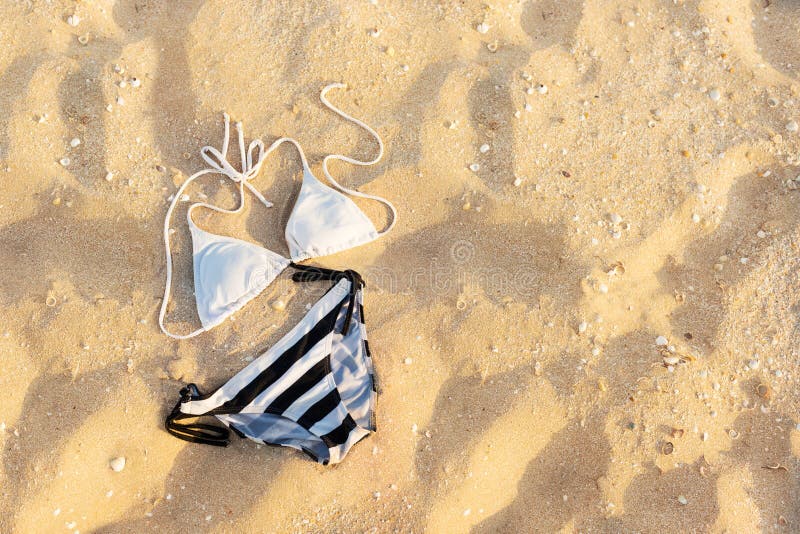 Swimsuit in the sand stock photo. Image of holiday, dress - 33875306