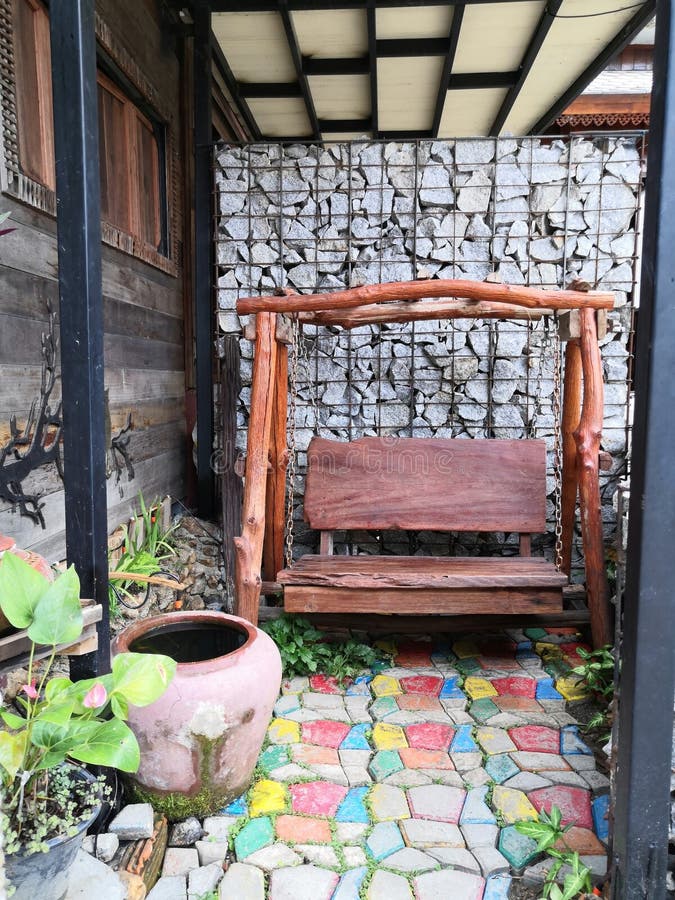 A Swing with a Broken Stone Wall Behind it Stock Photo - Image of ...