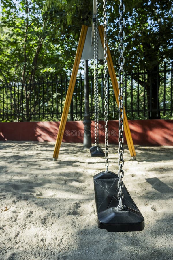 Swing Seat with Chains on a Playground with Sand on the Ground Stock ...