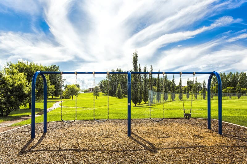 Swing Set in the Park stock photo. Image of summer, grass - 34112152