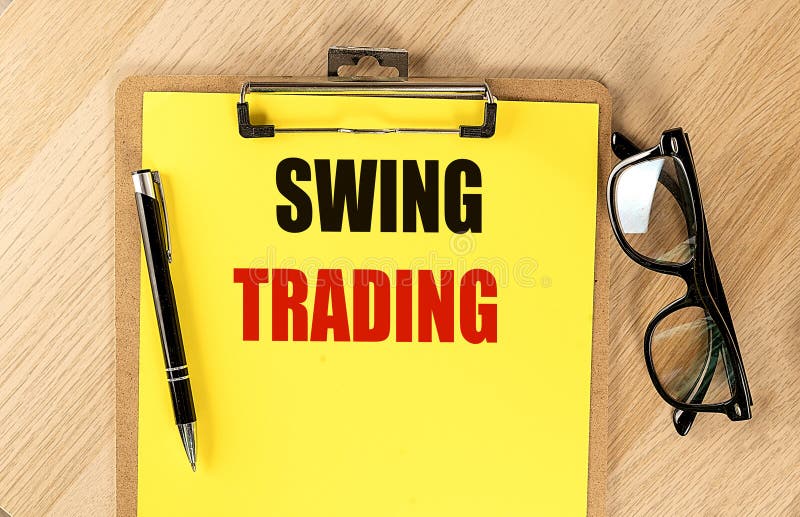 Swing Trading Concept with Financial Charts, Notepad, and Red Pen on a ...