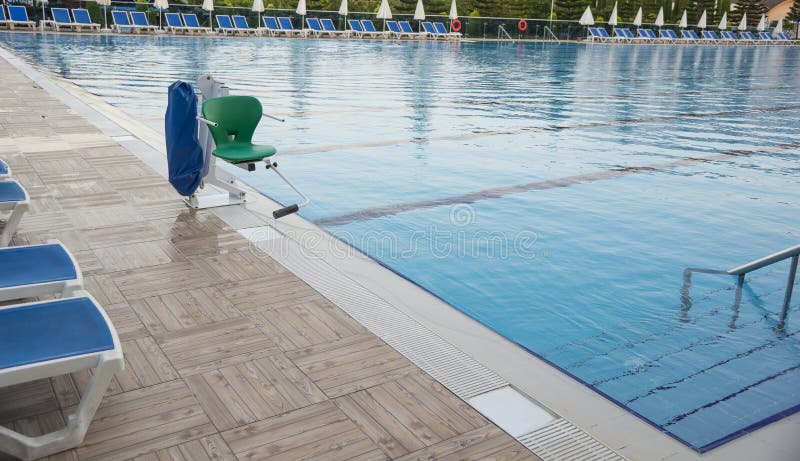 Swinging Arm Disabled Chair. Swimming Pool Lift with a Chair Stock ...