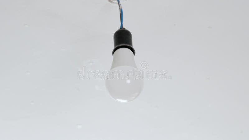 Swinging of an Electrical Energy Saving Light Bulb on a Wire Due To ...