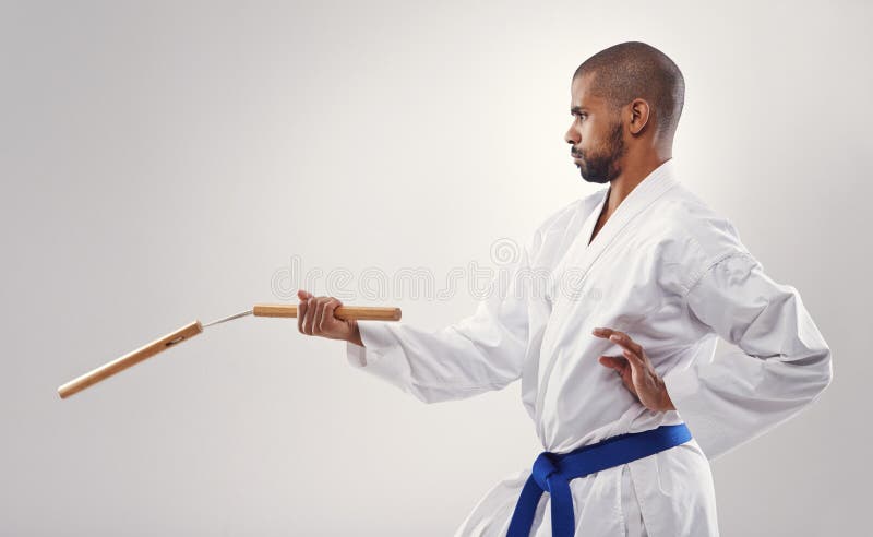 Swinging His Nunchucks Like a Pro. an African Man Doing Karate. Stock ...