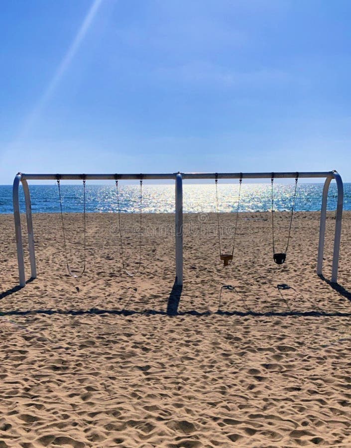 A set of Swings on Beach stock photo. Image of skies - 379651434