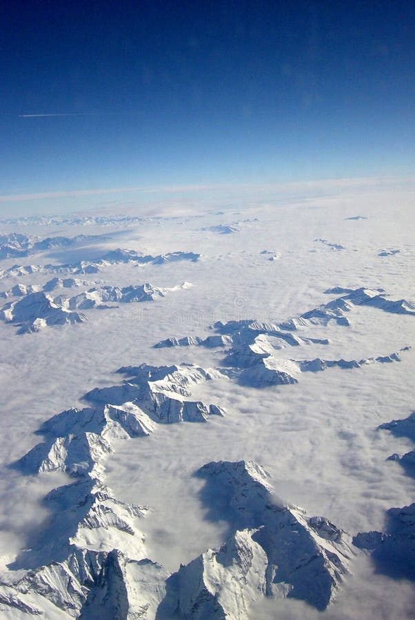 Swiss Alps from the air 3 stock photo. Image of clouds - 1093512