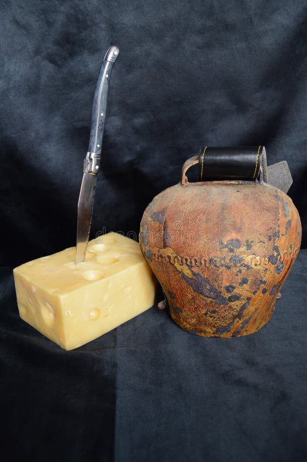 Swiss cheese with cowbell stock photo. Image of mountain - 77159714