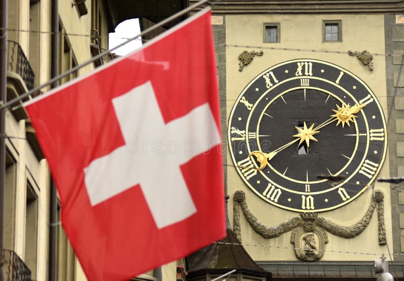 Swiss Flag Front of the Famous Clock Tower in Bern, Switzerland. Stock ...