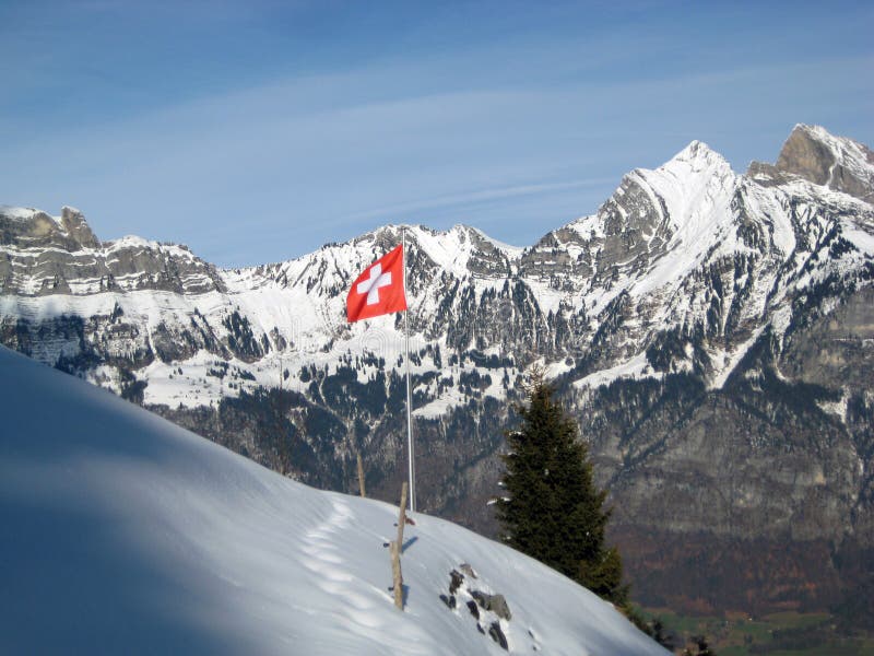 Swiss Flag in Front of Swiss Alps in Winter Stock Image - Image of ...
