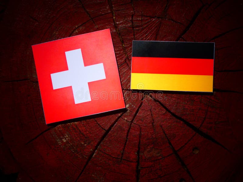 Swiss Flag with German Flag on a Tree Stump Stock Image - Image of ...