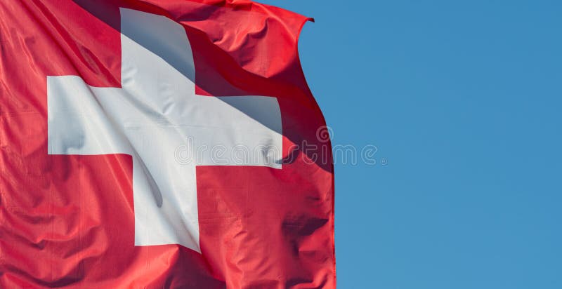 Swiss Flag. Switzerland Flag Against Blue Sky Stock Photo - Image of ...