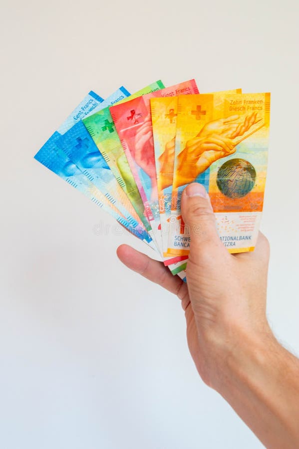 10 and 20 CHF Swiss Franc Banknotes in Hand Stock Photo - Image of male ...