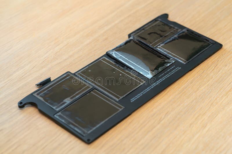 Swollen Battery of Broken Laptop on Wooden Table Closeup Stock Photo ...