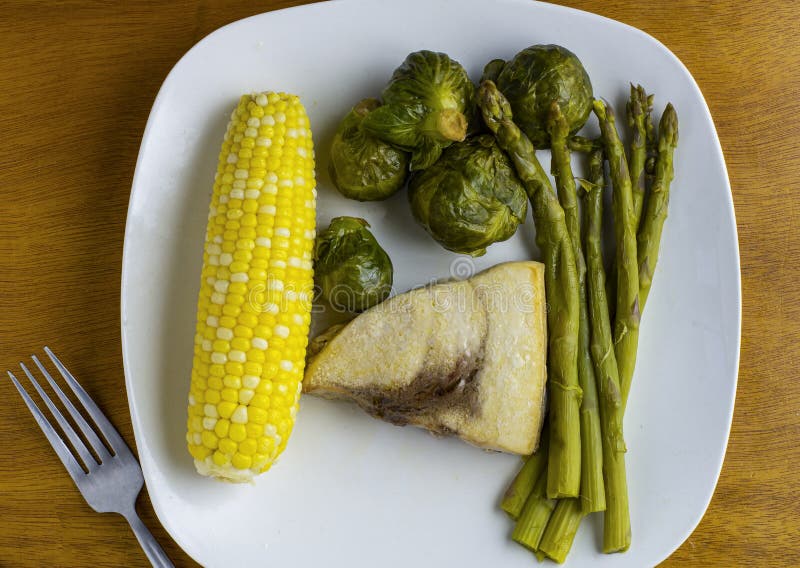 Sword Fish with Brussel Sprouts , Asparagus and Cor Stock Photo - Image ...