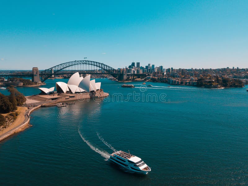 Sydney Opera House Surrounded by the Sydney Harbour with a Boat on it ...