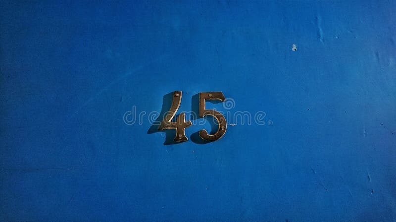 Symbol Number 45 on the Wall on a Blue Background. Stock Image - Image ...
