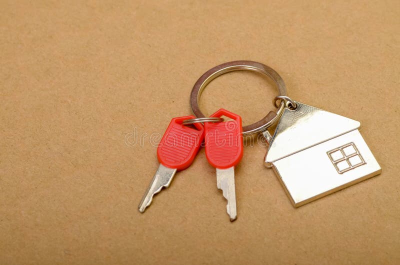 Symbol of Property Access: House-Shaped Keychain with Keys on a Brown ...