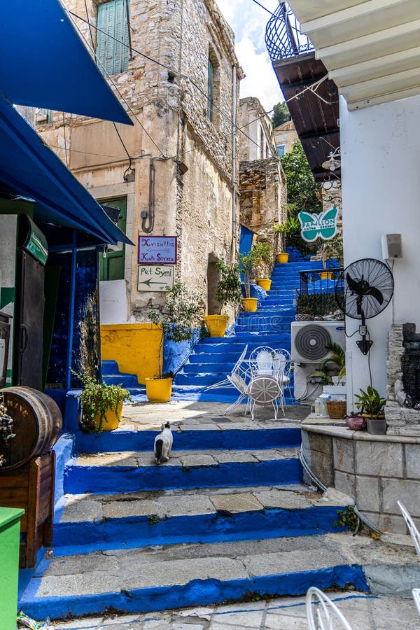 Symi, Greece - May 10, 2024: Blue Steps between Homes and Flower Pots ...