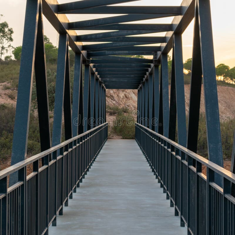 Symmetrical Bridge Walkway Under a Bright Blue Sky Stock Image - Image ...