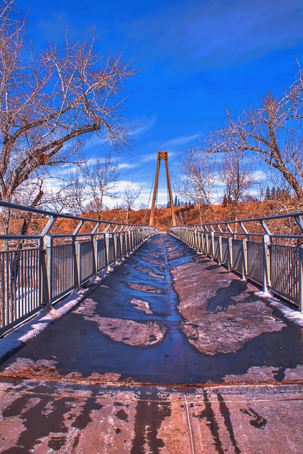 Symmetrical Bridge Walkway Under a Bright Blue Sky Stock Image - Image ...
