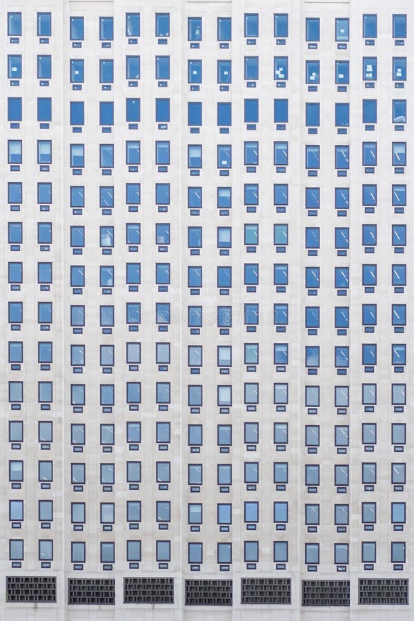 Symmetrical Building Facade Showcases Rows of Blue Tinted Windows ...
