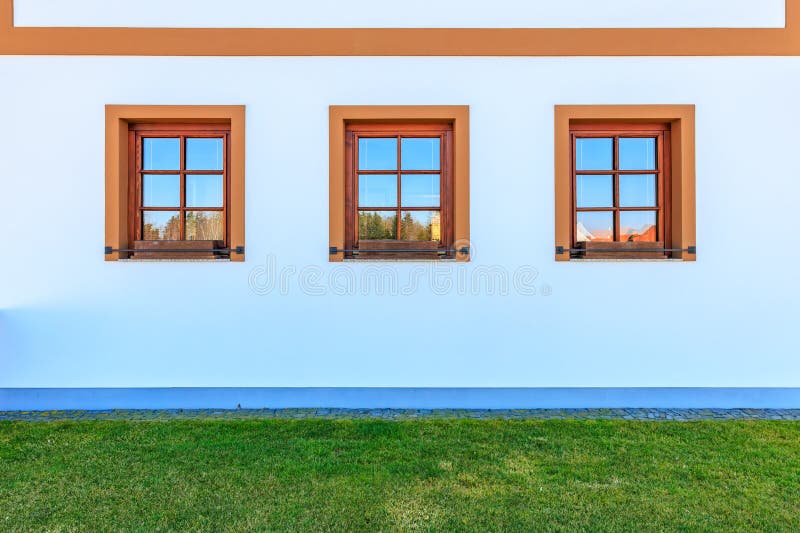 Symmetrical Triple Windows on White Building with Green Grass Lawn ...