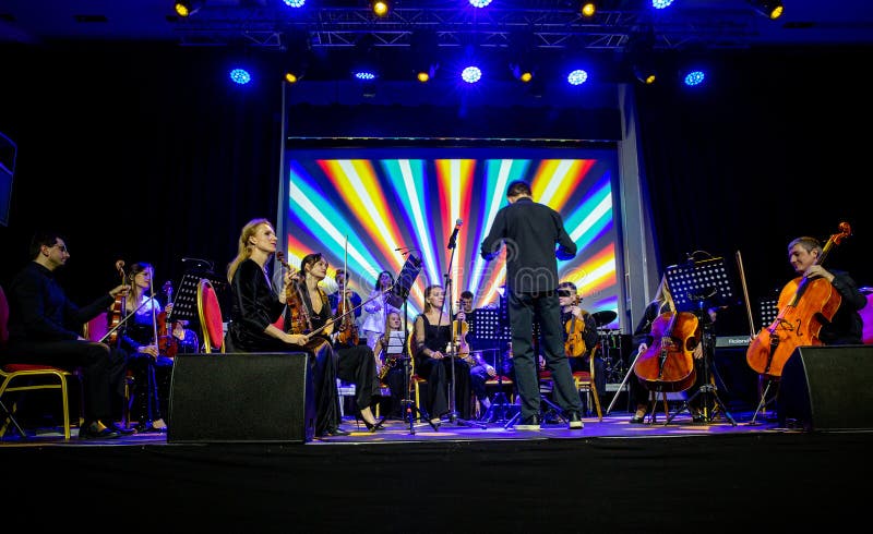 Symphony Orchestra Performing on Stage Under Bright Spotlights and ...