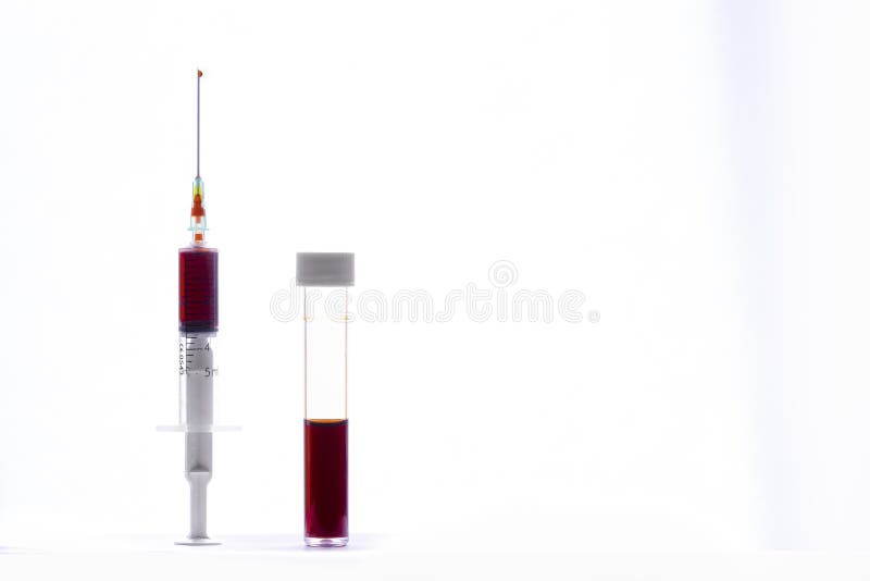Syringe with Blood and a Drop of Blood on the Needle and a Blood Test ...