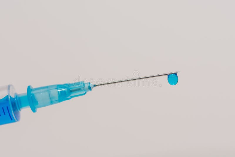 Syringe with a Blue Fluid Vaccine and a Drop on the Front Stock Photo ...