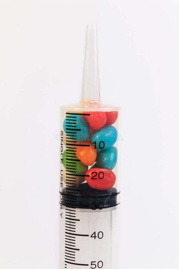 A Syringe and Candy Bottle Isolate on White Background. Stock Image ...
