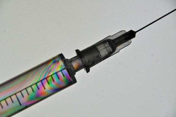 A Syringe with Colorful Rainbow Liquid Inside, an Injection with a ...
