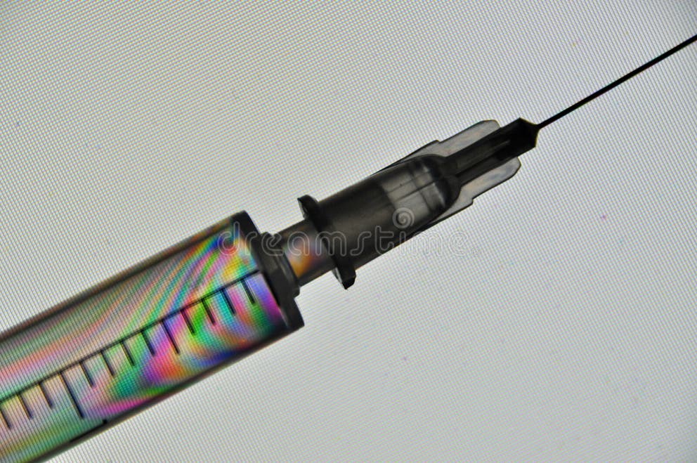 A Syringe with Colorful Rainbow Liquid Inside, an Injection with a ...
