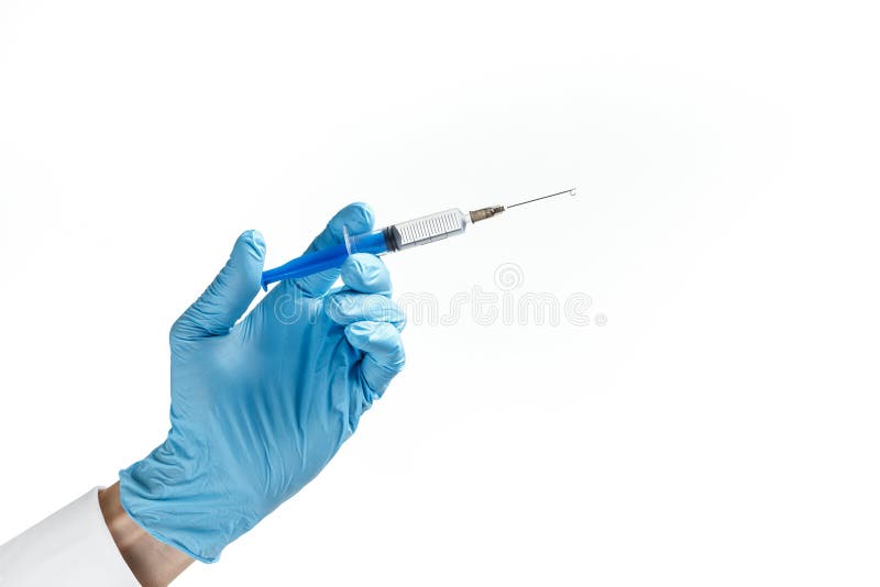 Syringe with a Drop on a Needle in Hand in a Blue Rubber Glove on a ...