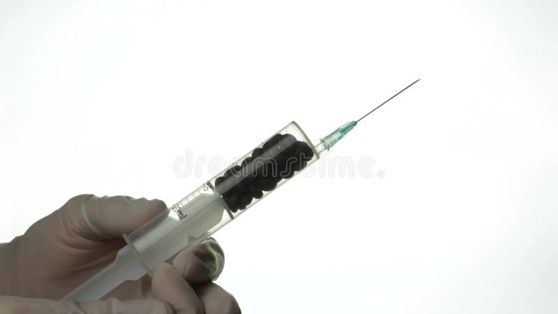 The Syringe Filled with Coffee Beans in the Hands of the Nurse. Coffee ...