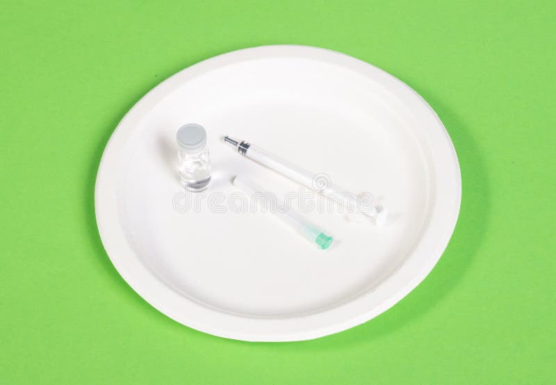 Syringe Injection or Medical Needle on Simple Plate Isolated on Green ...