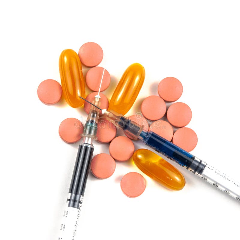 A Syringe with an Injection Solution and Vitamins with Pills Stock ...