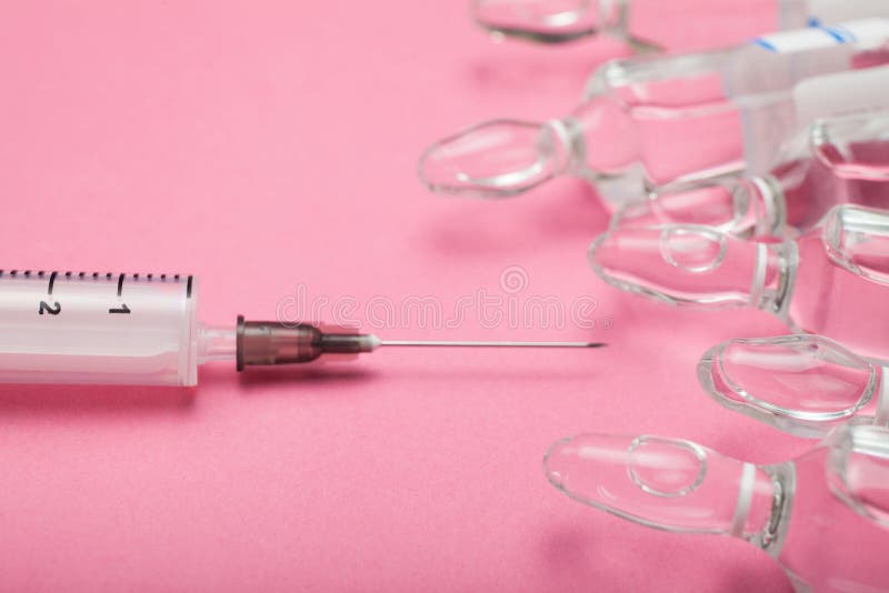 Syringe and Ampoules on a Pink Background. Injections for Face and Skin ...
