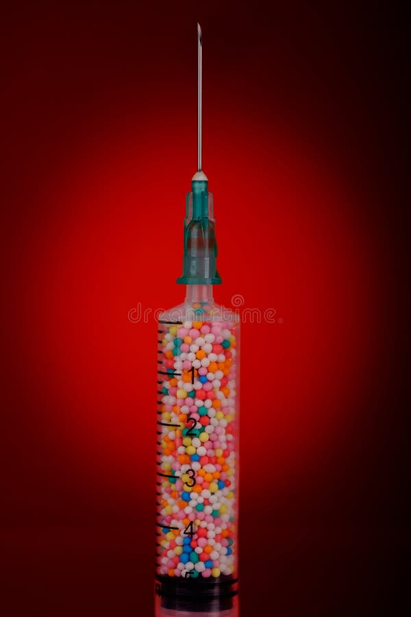 Syringe with Needle and Liquid Drugs in the Barrel in a Studio with ...