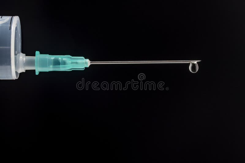 Syringe Needle with an Injection Solution on Black Background, Copy ...