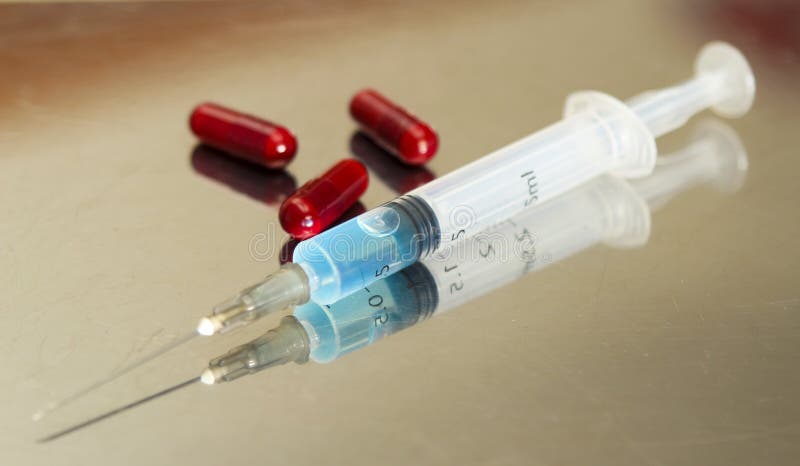 Syringe Next To Three Red Capsules Stock Photo - Image of chemistry ...
