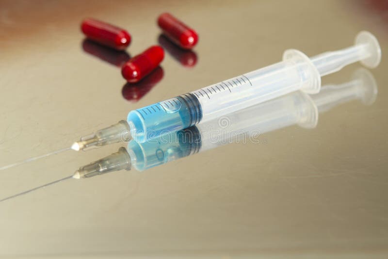 Syringe Next To Three Red Capsules Stock Image - Image of liquid ...
