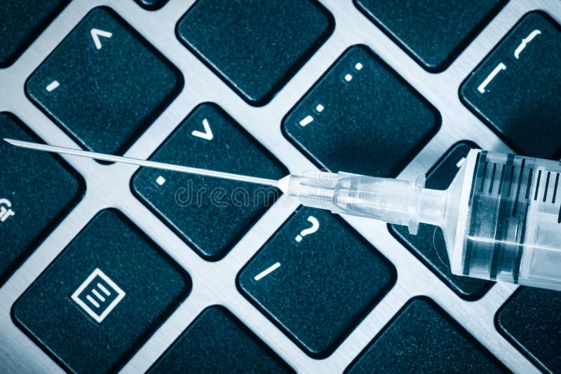 Syringe Over a Computer Keyboard Toned in Blue Stock Photo - Image of ...