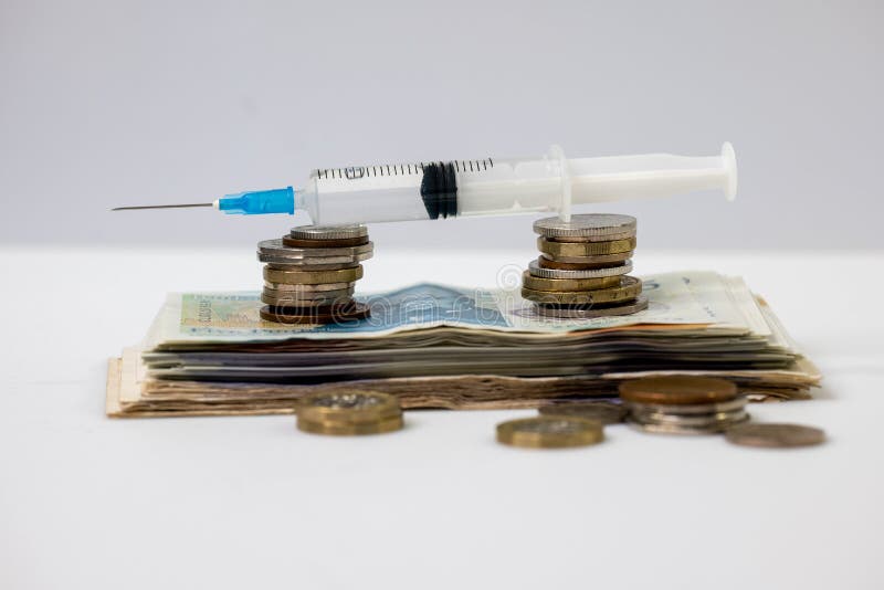 A Syringe Placed on Top of Money Stock Photo - Image of coronavirus ...