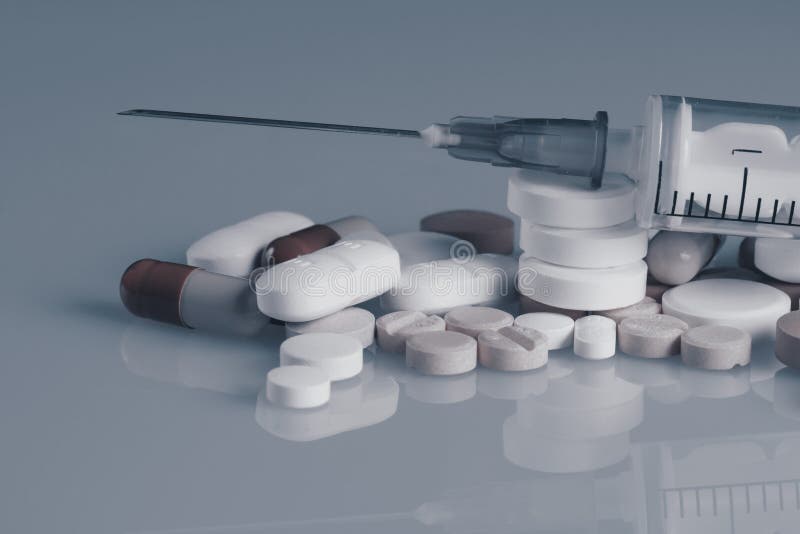 Syringe and tablets stock photo. Image of laying, needle - 67274364